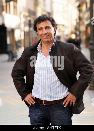 Portrait of smiling happy man standing on gray studio background Stock ...