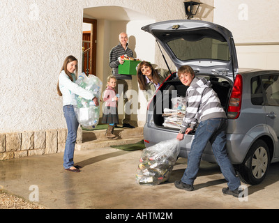 Family loading car boot with recycling Stock Photo - Alamy
