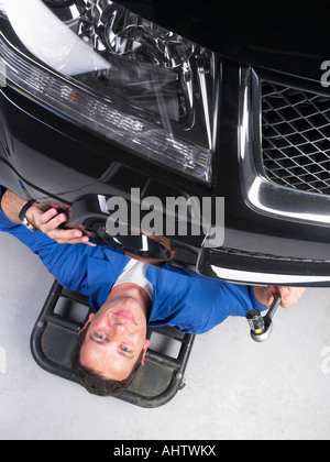 overhead view of car mechanic repairing car in car service Stock Photo ...