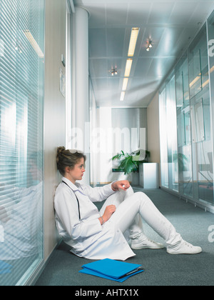 Doctor sitting on the floor in hospital Stock Photo - Alamy
