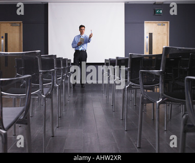 Man practicing speech in empty presentation room Stock Photo - Alamy