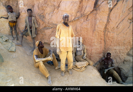 Artisanal gold miners taking a break from at a small, primitive mine at ...