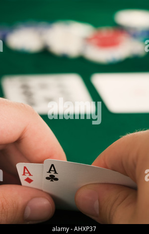 Poker table with a player's hand with aces Stock Photo - Alamy