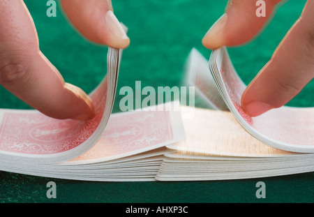 Hands shuffling playing cards on outdoor chess board setup Stock Photo ...