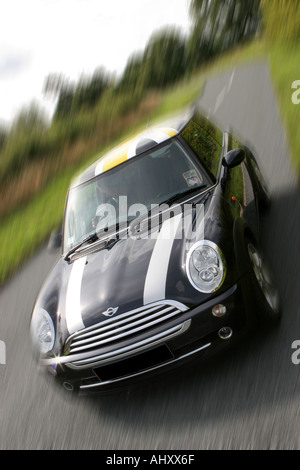 Speeding Mini Cooper on country lane Stock Photo - Alamy