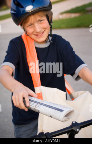 Newspaper carrier delivering newspapers Stock Photo - Alamy
