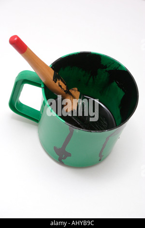 paintbrush dipped in green plastic bucket with turpentine Stock Photo ...