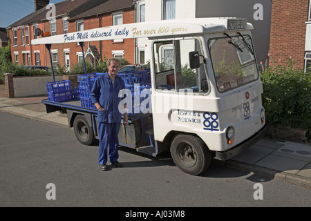 Milkman delivering milk from a milk float in Bath, Somerset, England ...