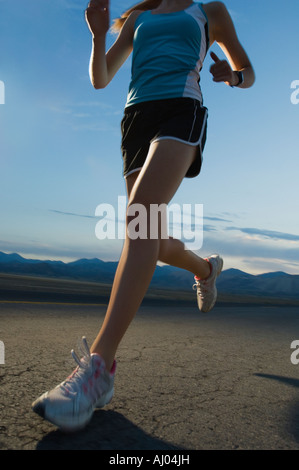 Athletic woman running in countryside Stock Photo - Alamy