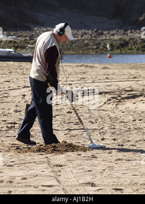 Retired man using a metal detector on Siesta Key beach Florida during ...