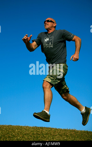 Low angle shot of a beautiful bald eagle flying in a blue sky over ...