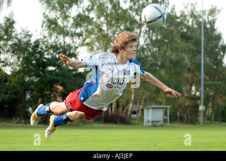 teenage boy jumping to head a football at soccer practise Stock Photo ...