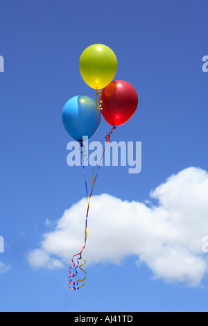 Helium balloons floating into the sky Stock Photo - Alamy
