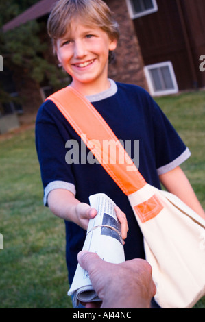 Newspaper carrier delivering newspapers Stock Photo - Alamy
