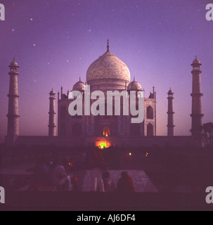 The Taj Mahal at night, illuminated and with a dark background, looks ...