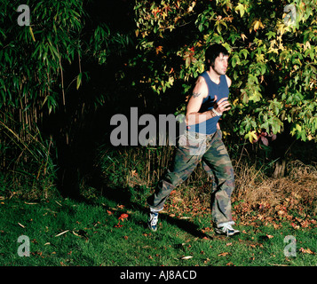 a man running through the woods at night Stock Photo - Alamy