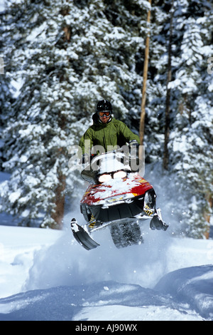 Man jumping snowmobile Stock Photo - Alamy