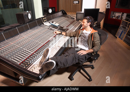 Inside a music recording studio with mixing desk and recording ...