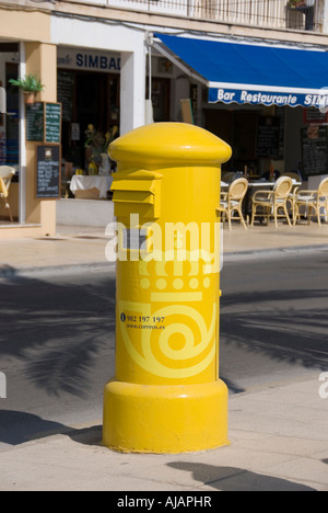 A bright yellow Correos post box (Correos is the Spanish postal service ...