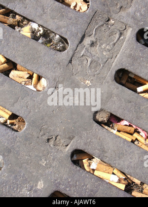 cigarette stubs in drain Stock Photo - Alamy