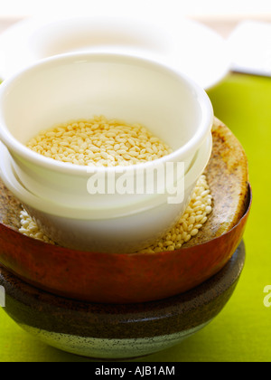 Grains of rice in bowls on table on sackcloth background Stock Photo ...