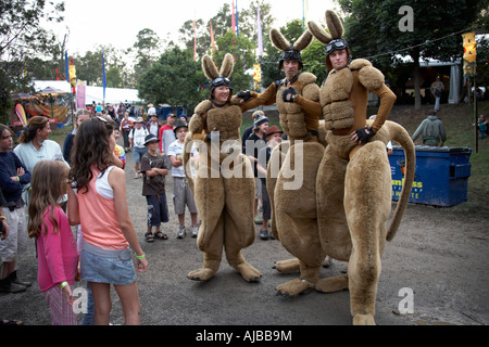 People strolling around stalls with comic walk around bouncing kangaroo ...