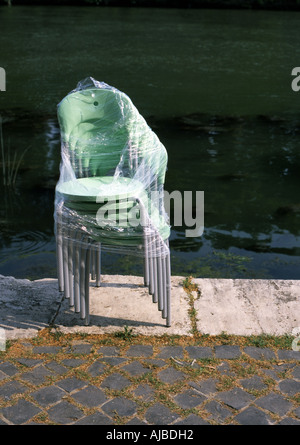 stack of brand new chairs by river bank Stock Photo - Alamy