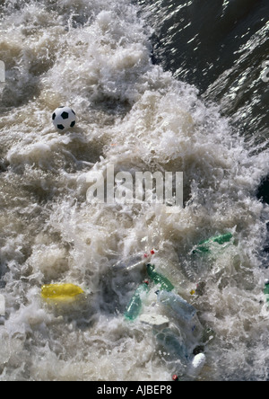 football and rubbish blocked in river waterfall Stock Photo - Alamy