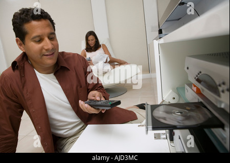 man using dvd player in living room Stock Photo - Alamy