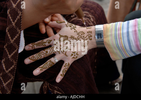 Berber women putting henna tattoo on tourists hand Djemma el Fna ...