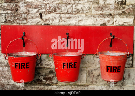 Red fire buckets filled with sand Stock Photo - Alamy