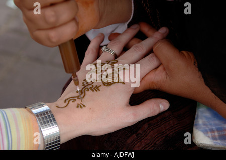 Berber women putting henna tattoo on tourists hand Djemma el Fna ...