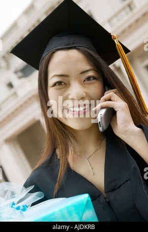 Portrait Of University Graduate Using Mobile Stock Photo - Alamy