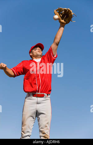 Baseball player catching ball in baseball glove, close-up of hand in ...