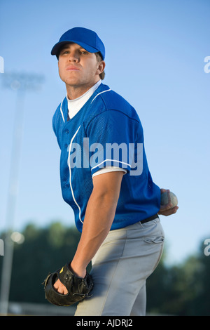 Pitcher holding baseball behind back Stock Photo - Alamy