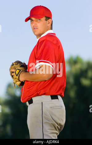 Pitcher Baseball Player on a Red Uniform on red lights background Stock ...
