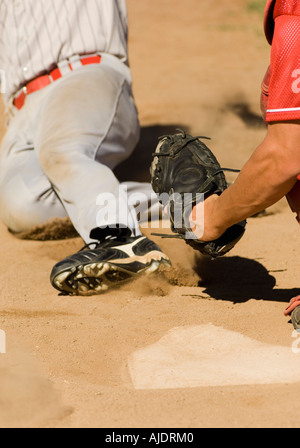 Baseball player sliding into home base Stock Photo - Alamy