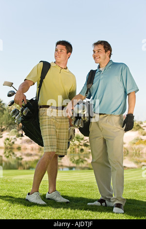 Two smiling golfers standing next to each other Stock Photo - Alamy