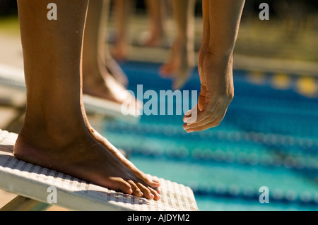 Young swimmers standing on the starting blocks at swimming pool Stock ...