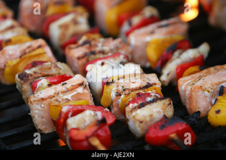 fresh fish on grilling sticks salmon and halibut with red and yellow ...