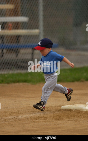 Toddler runs around the bases after a youth baseball game Stock Photo ...