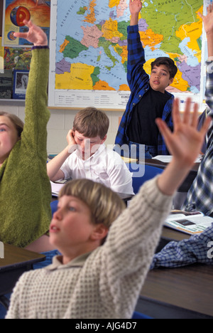 Underachieving student sitting a mixed group of enthusiastic classmates ...