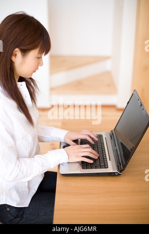 Young woman using computer on green grasses in the park. Education ...