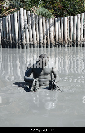 Man having a mud bath near Dalyan village and Koycegiz lake in Turkey ...