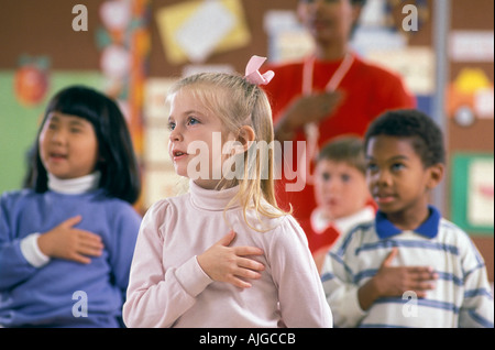 Preschool students in class pledging allegiance to the flag Stock Photo ...