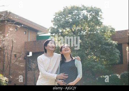 Young pregnant couple outdoors in spring Stock Photo - Alamy