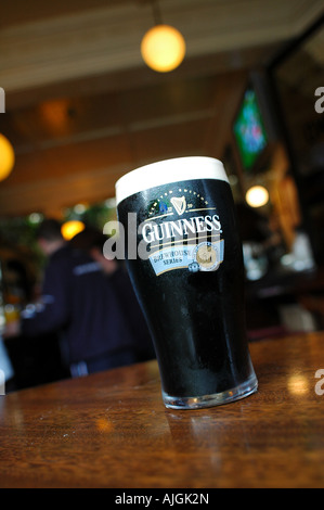 Guinness pint in his hand Stock Photo - Alamy