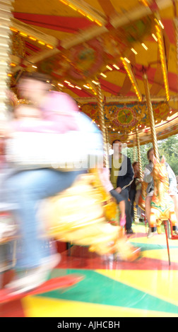 Carousel Merry go round blurr Stock Photo - Alamy