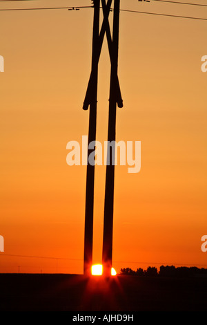 Sun setting behind Saskatchewan Hydro power poles Stock Photo - Alamy
