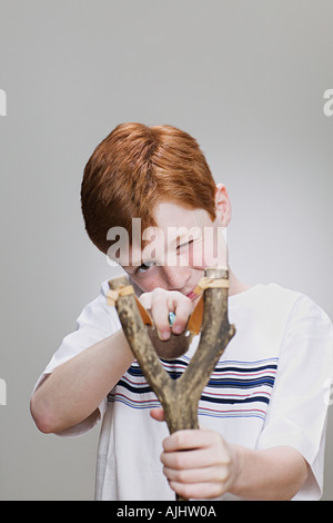 Boy using a catapult Stock Photo - Alamy